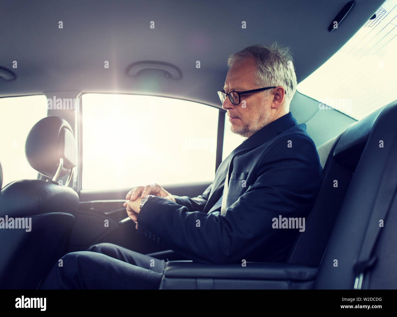 senior businessman driving on car back seat Stock Photo - Alamy