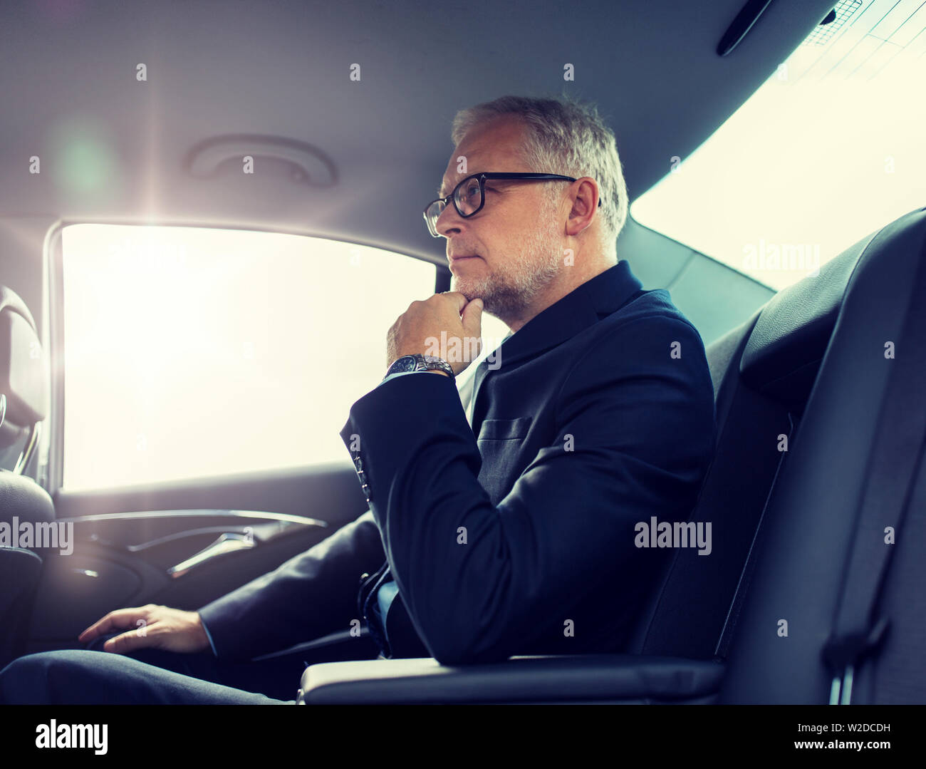 senior businessman driving on car back seat Stock Photo - Alamy
