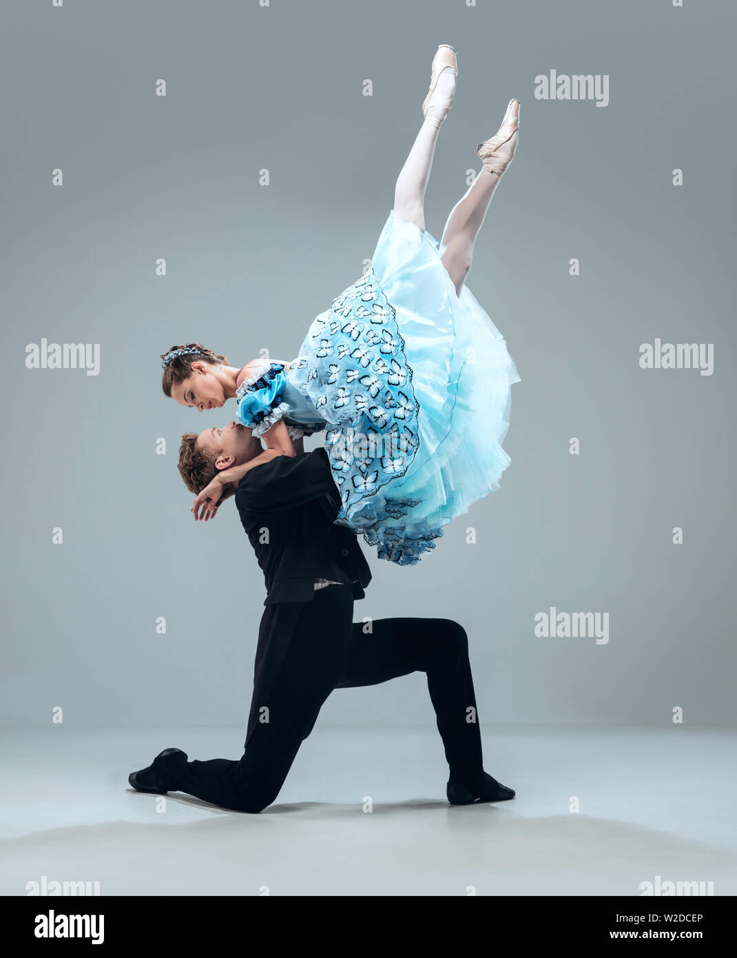 Sky's eyes. Beautiful contemporary ballroom dancers isolated on grey ...