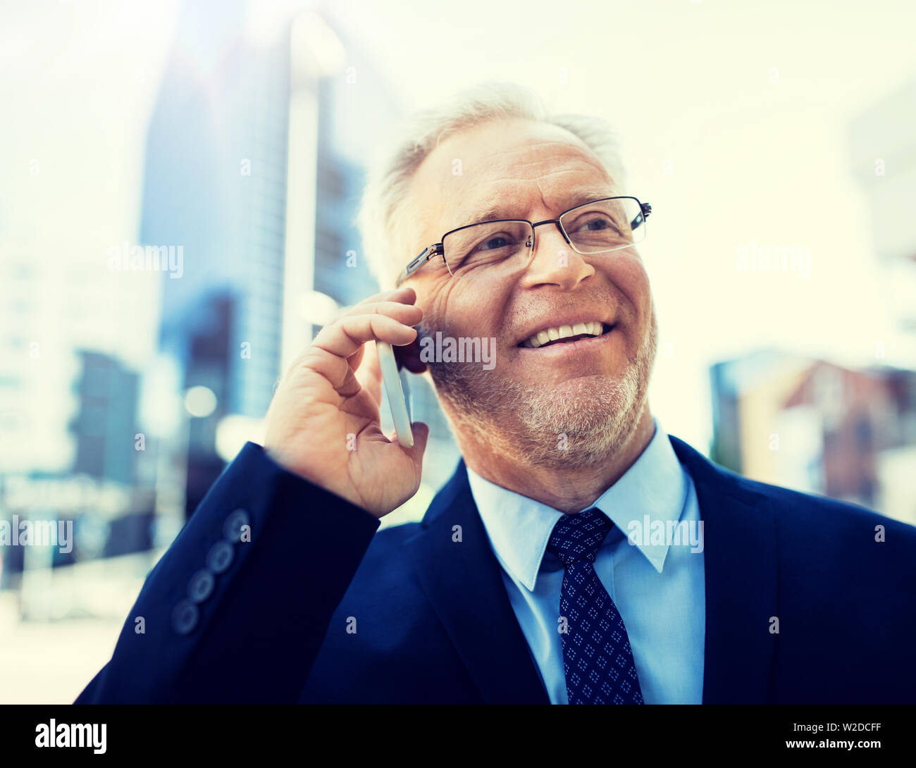 smiling old businessman calling on smartphone Stock Photo - Alamy