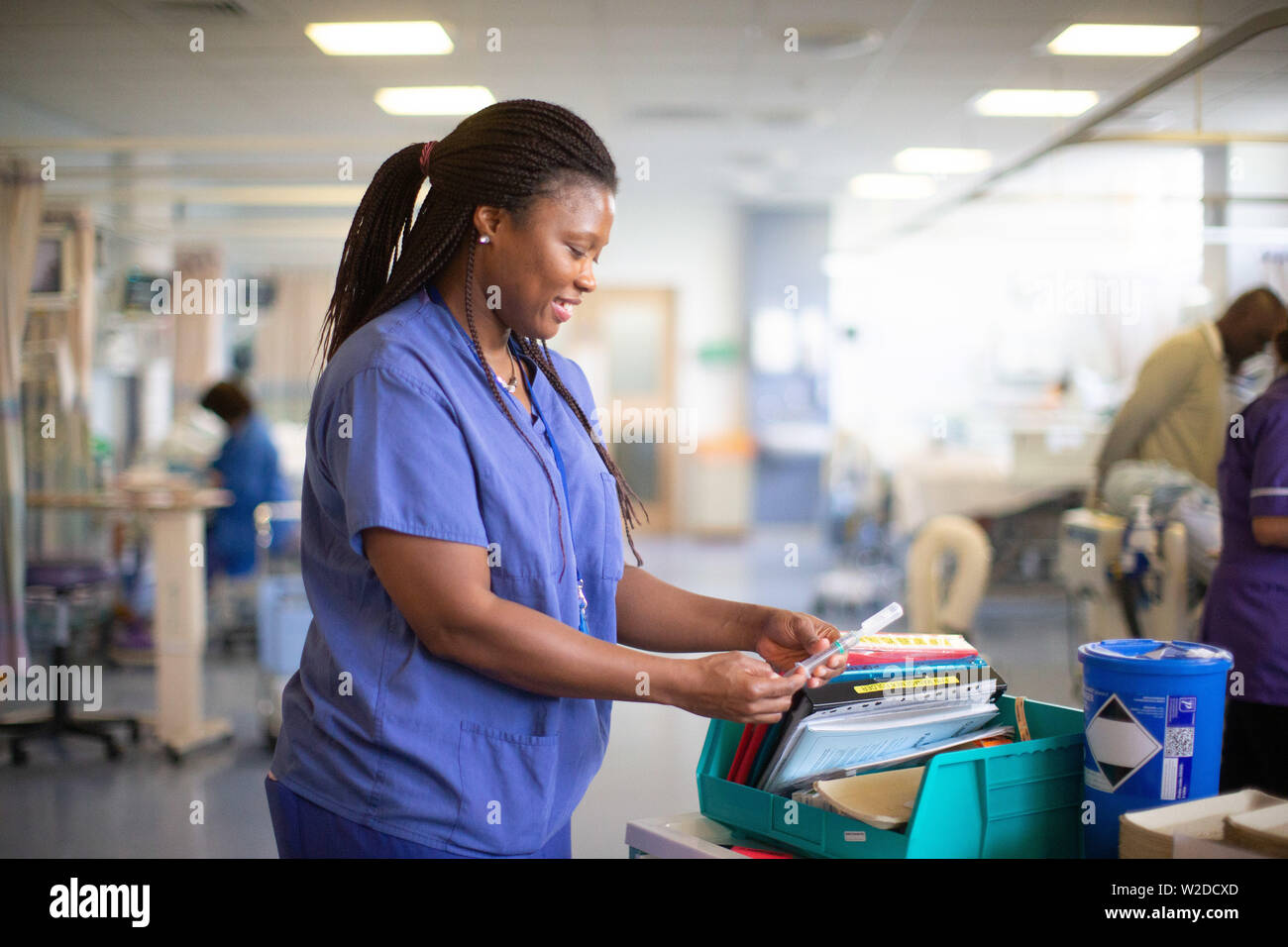 Nhs nurse studying patients notes hi-res stock photography and images ...