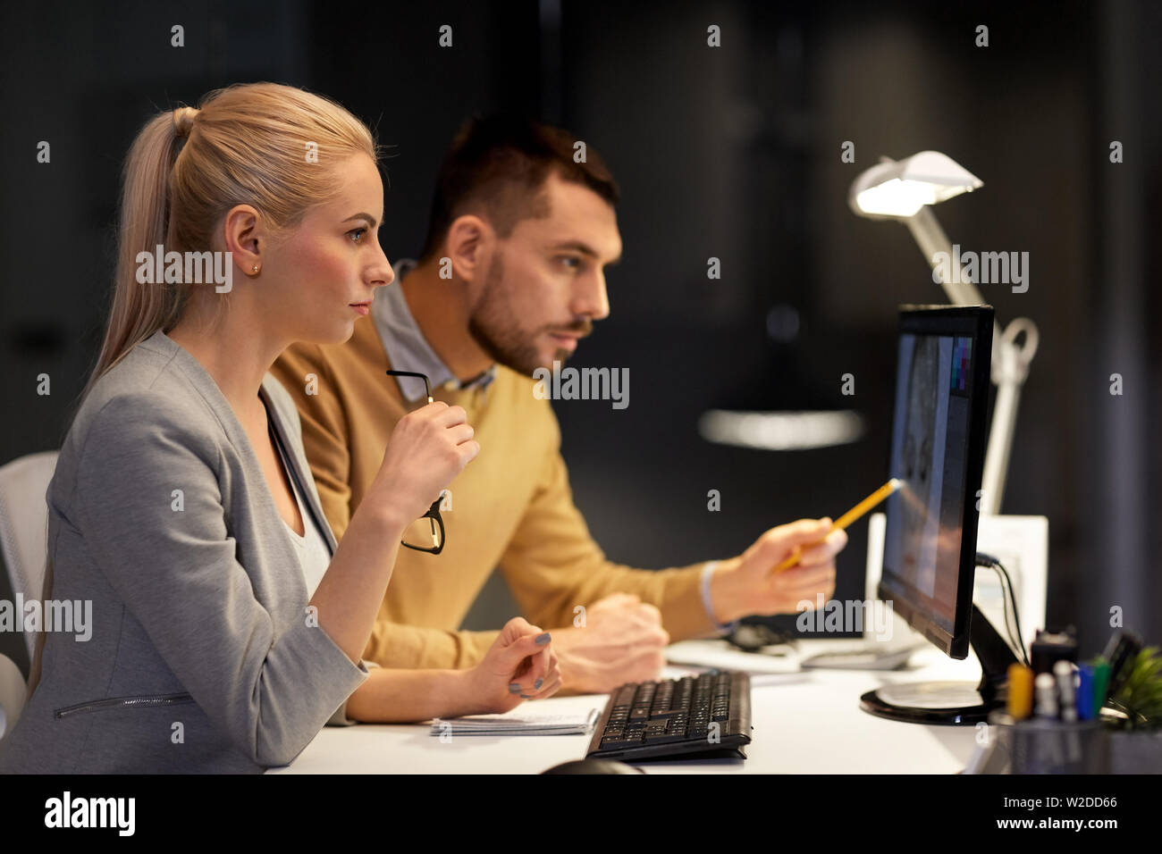 designers with computer working at night office Stock Photo - Alamy