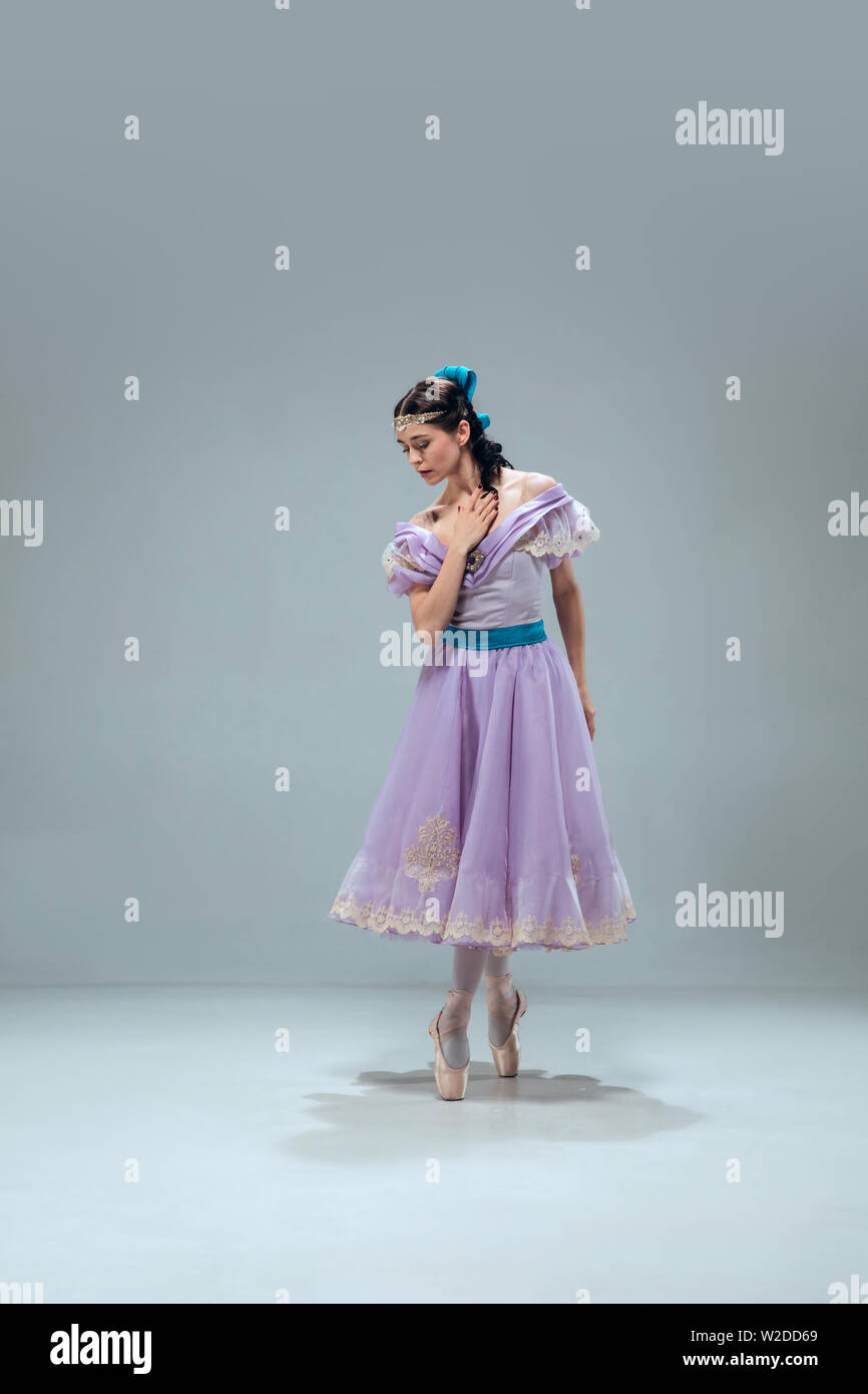 Sadness. Beautiful contemporary ballroom dancer isolated on grey studio ...