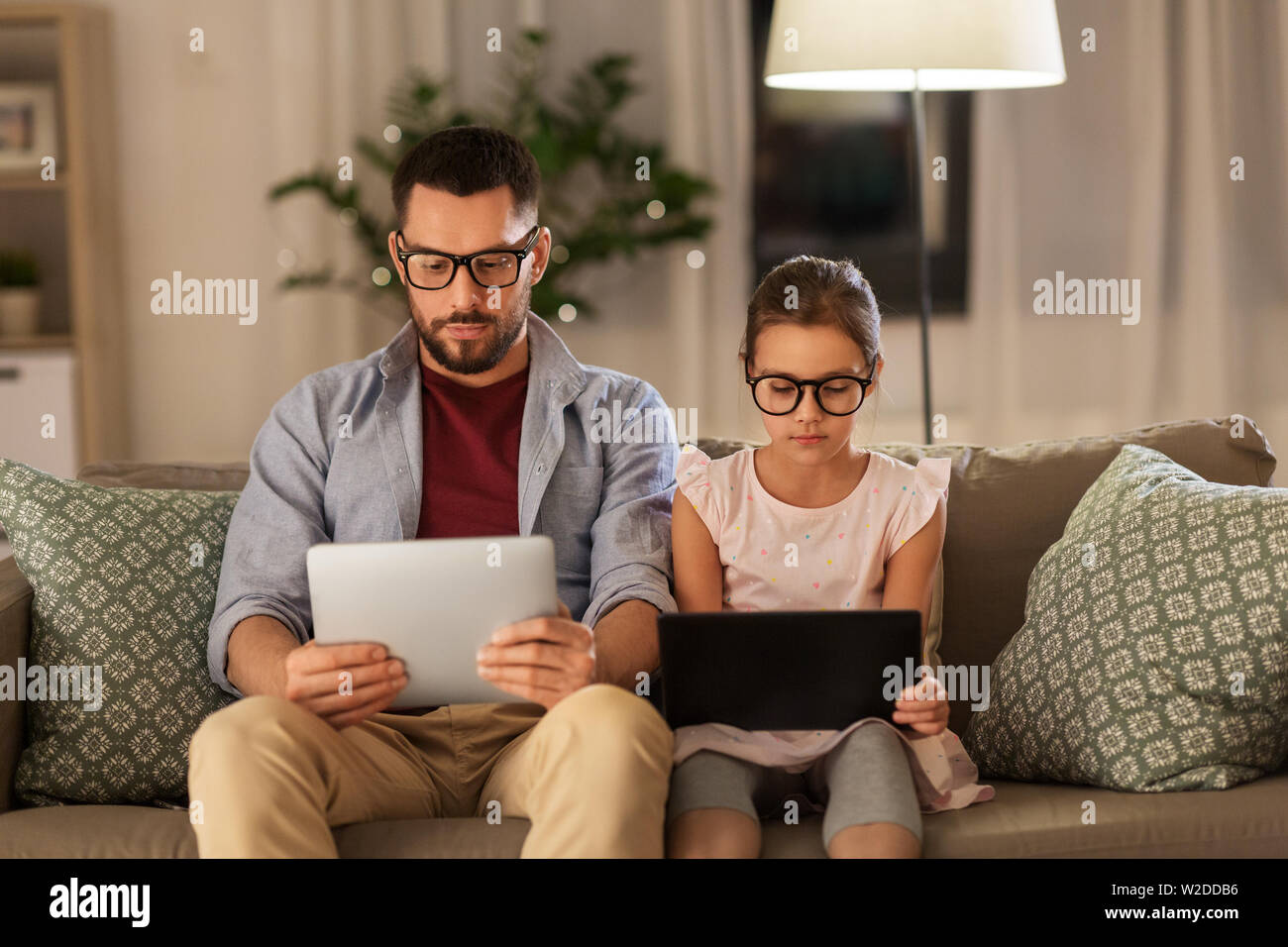 father and daughter with tablet computers at home Stock Photo - Alamy