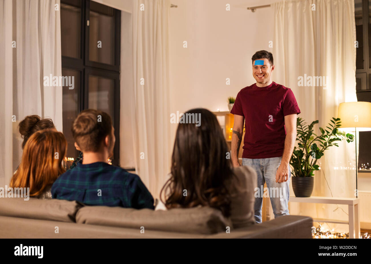 friends playing guessing game at home in evening Stock Photo - Alamy