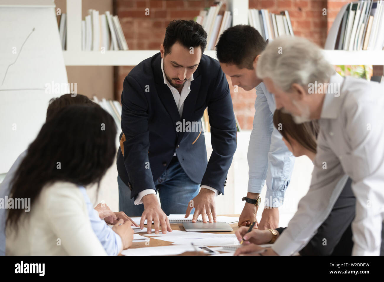 Multiethnic business team people with male boss manager discuss ...