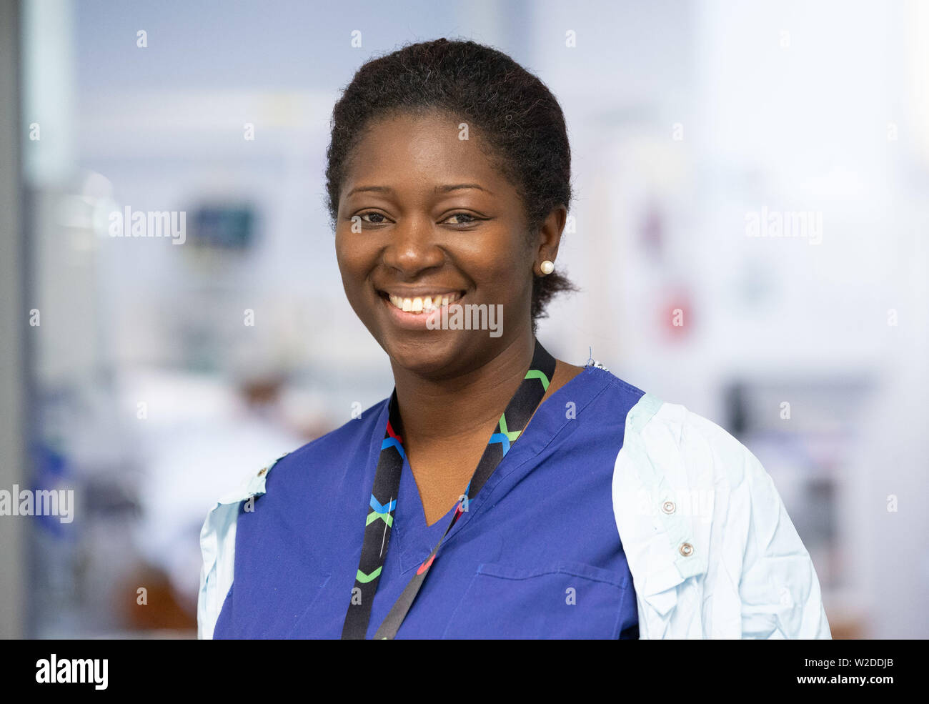 Smiling Hospital nurse in an NHS Hospital ward Stock Photo - Alamy
