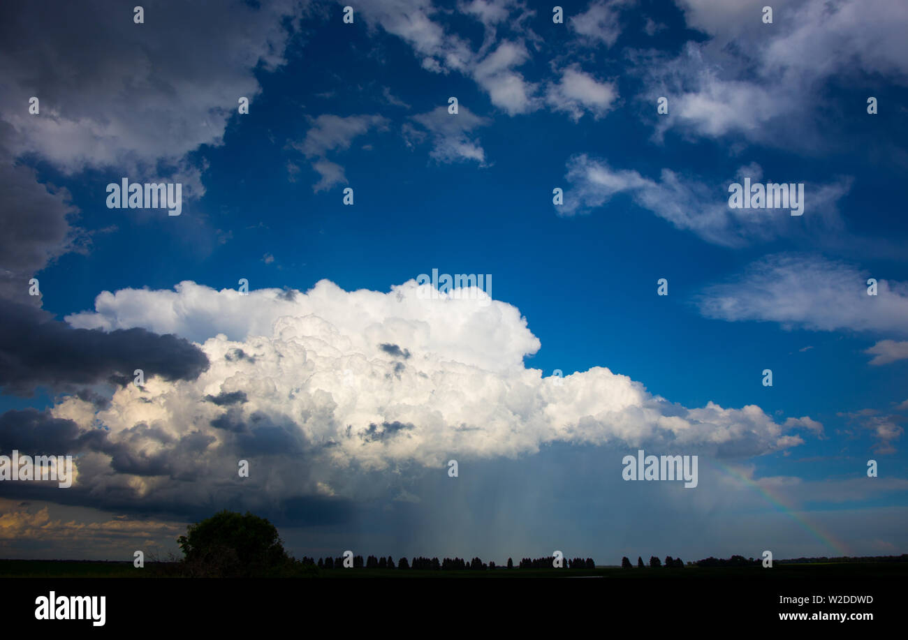 Super-Cell Thunderstorm With Rainbow and rain Stock Photo - Alamy