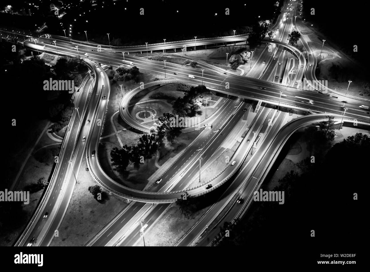 Aerial view of big highway interchange with traffic at night. Scenic ...