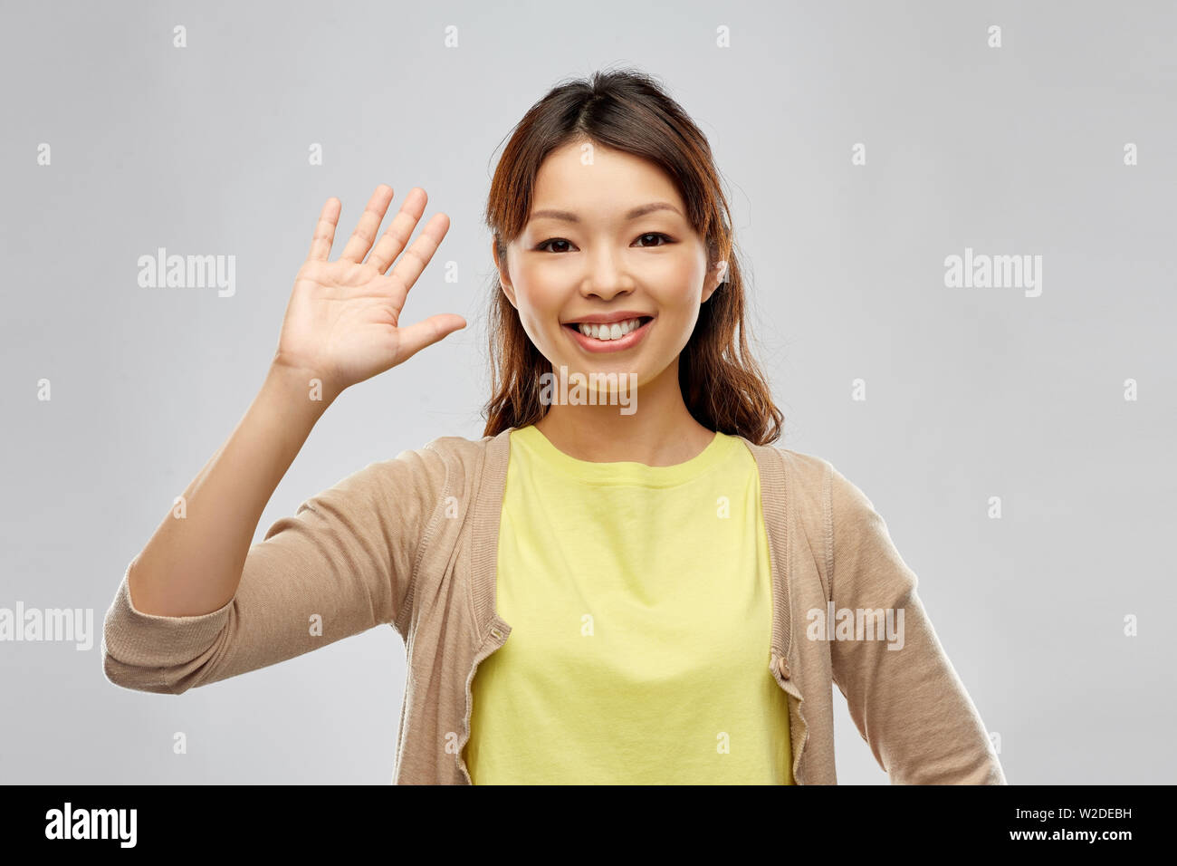 happy asian woman waving hand Stock Photo - Alamy