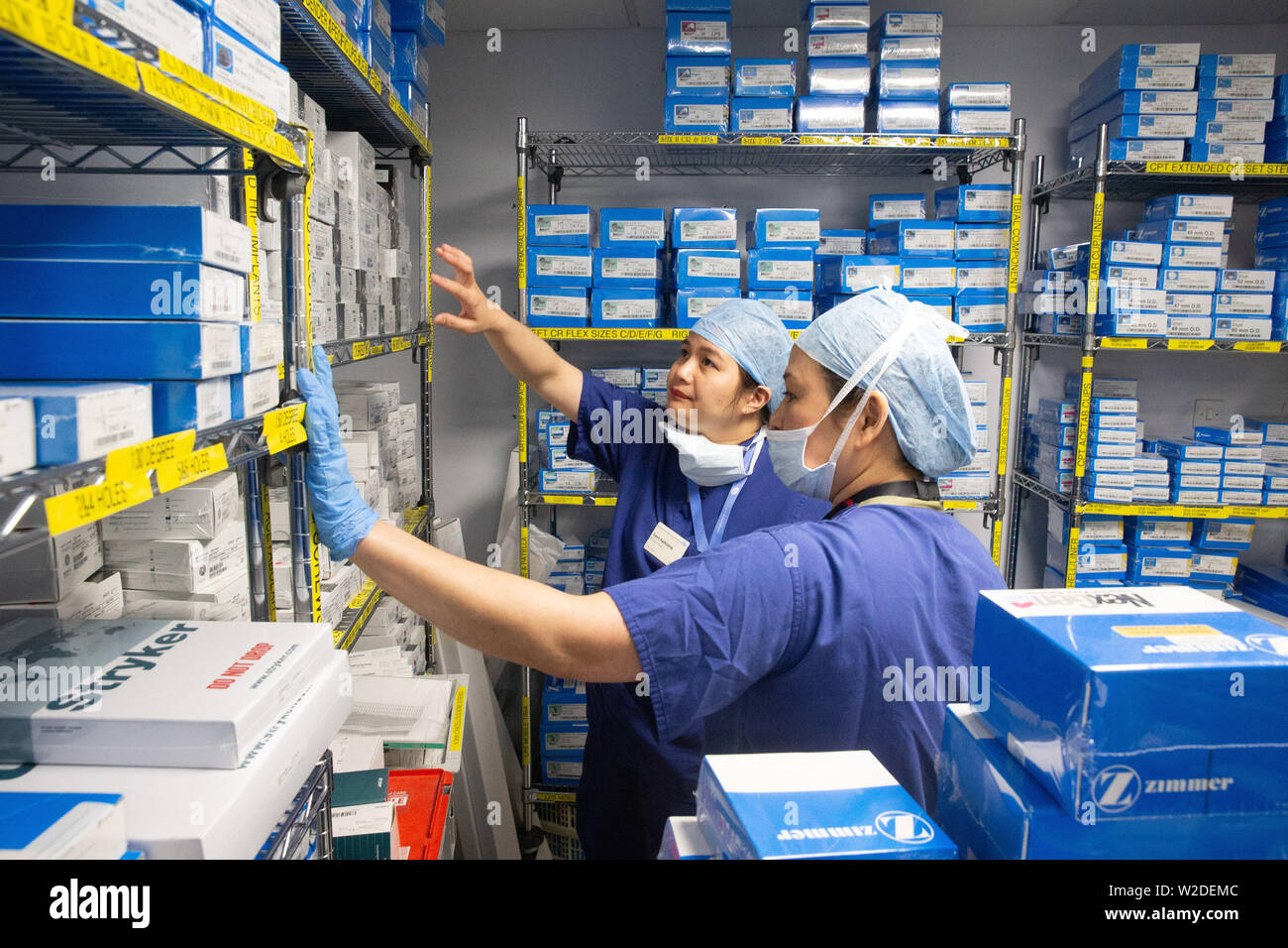 Nurses check supplies in a storeroom in an NHS Hospital Stock Photo - Alamy