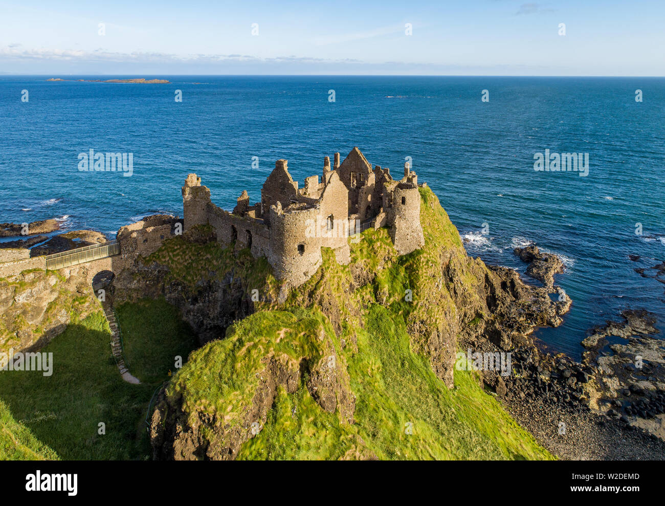 Ruins of medieval Dunluce Castle on a steep cliff. Northern coast of ...