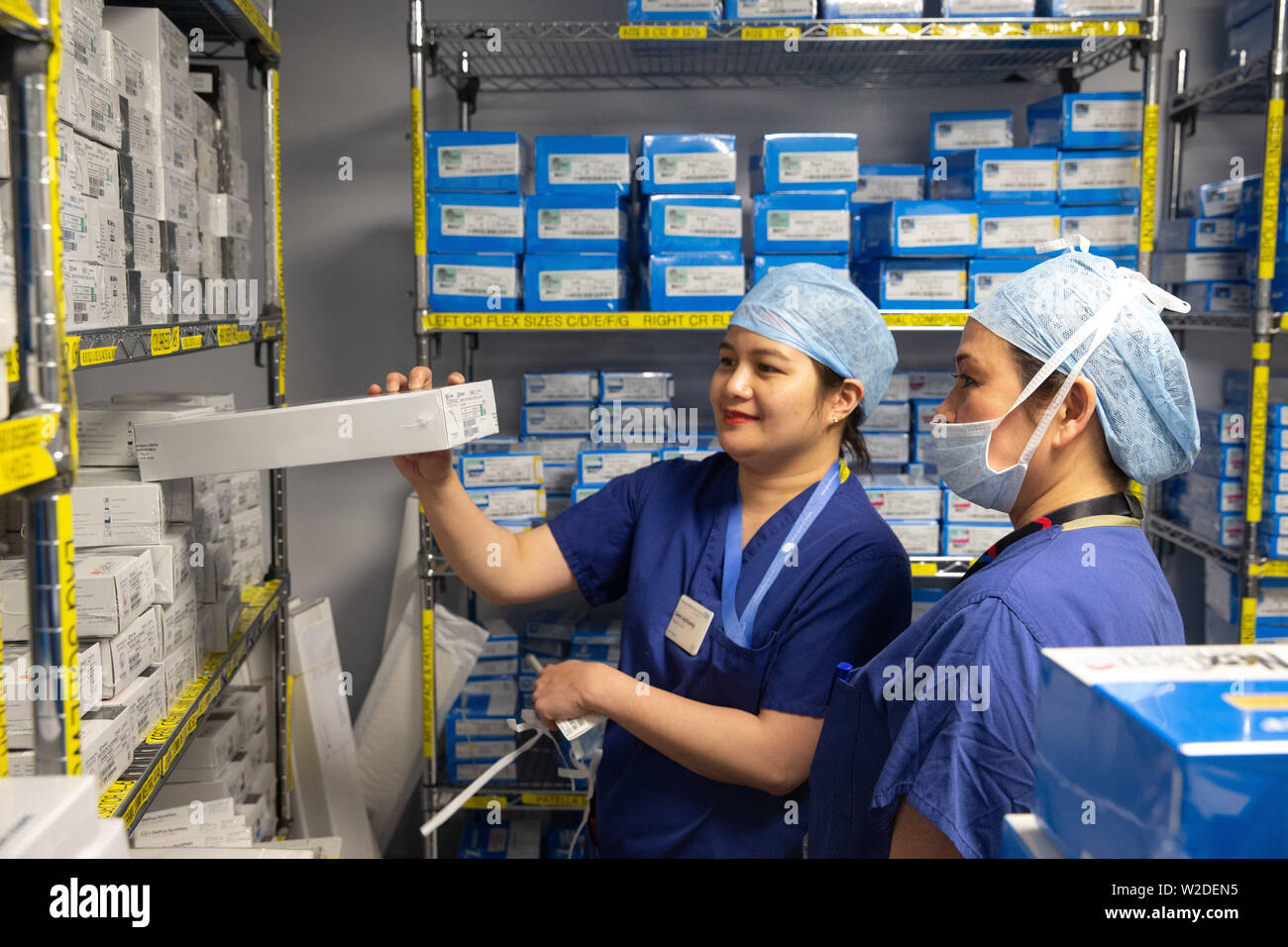 Nurses check supplies in a storeroom in an NHS Hospital Stock Photo - Alamy