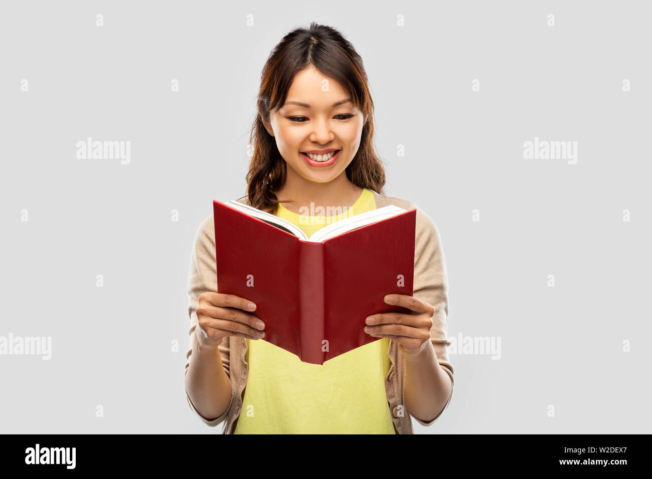 happy asian woman reading book Stock Photo - Alamy