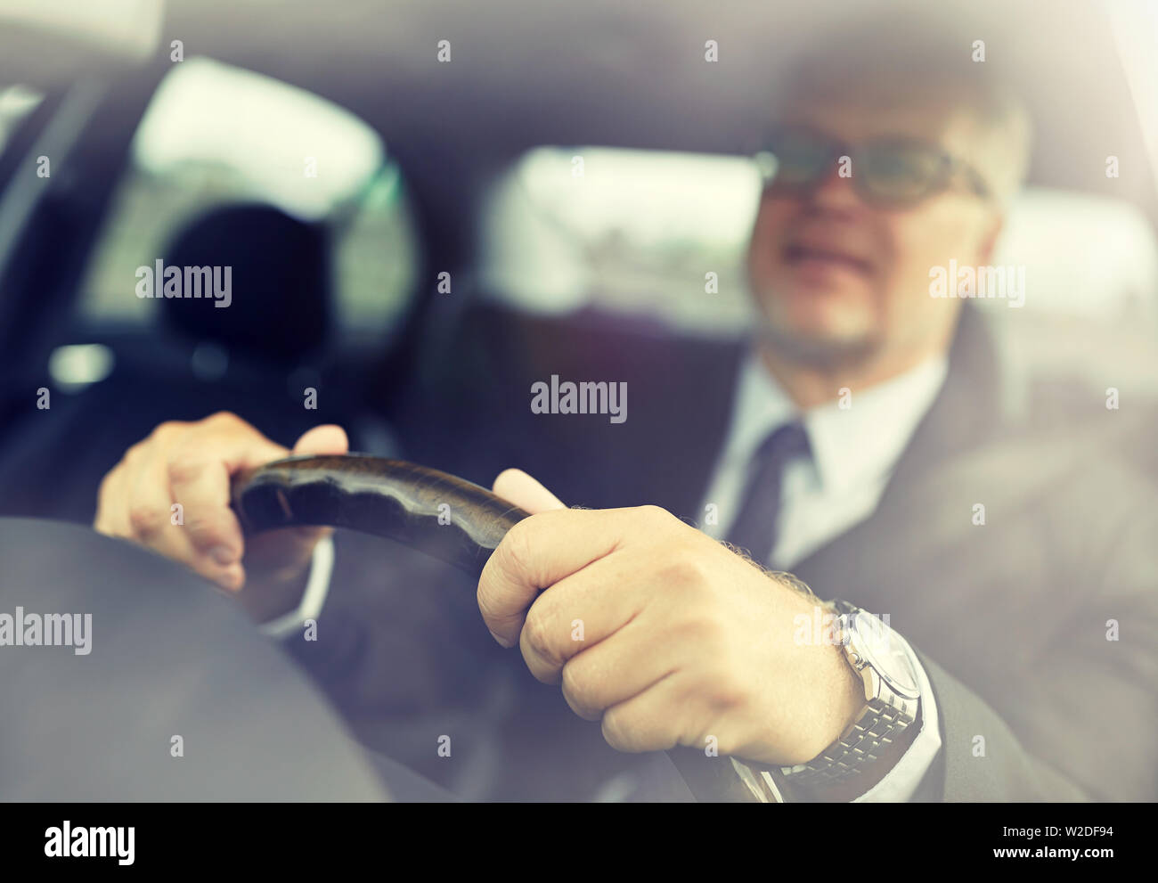 senior businessman hands driving car Stock Photo - Alamy