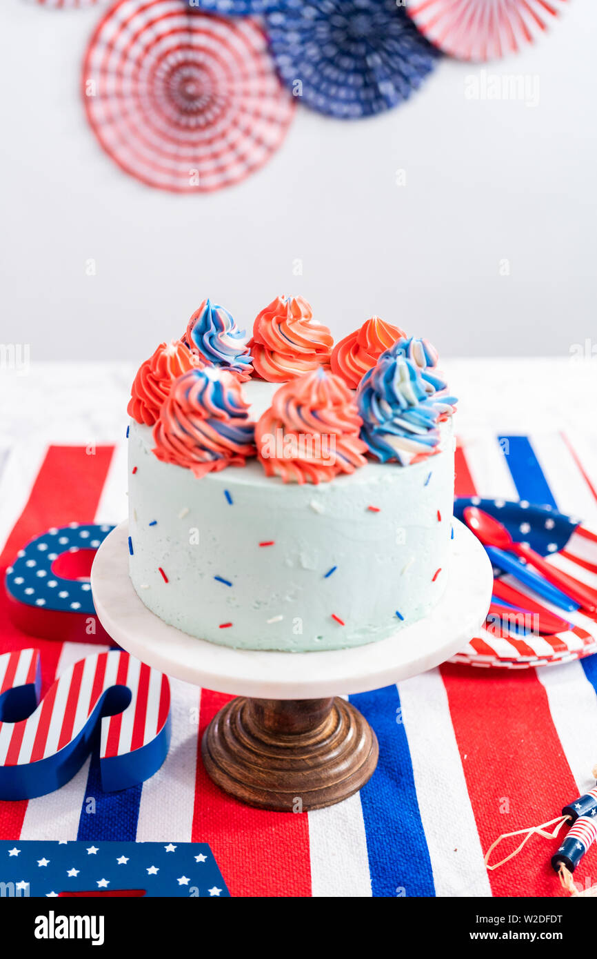 Red, white, and blue round vanilla cake with buttercream frosting for ...
