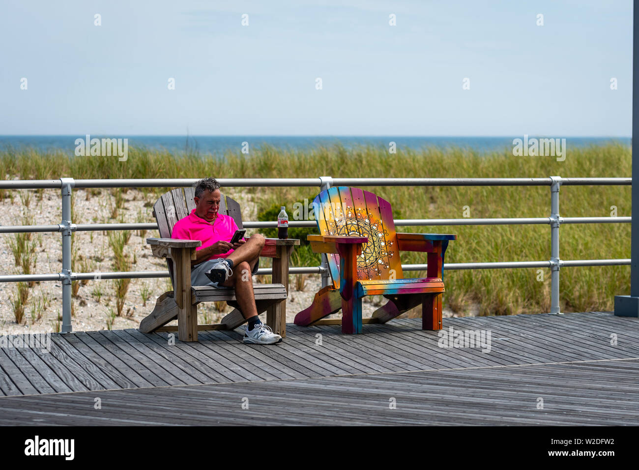 ATLANTIC CITY, NEW JERSEY - JUNE 18, 2019: A man resting on a bench at ...