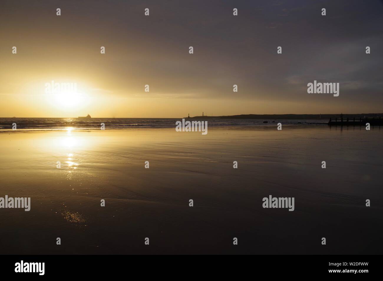 Sandy coastal beach sunrise lighthouse background hi-res stock ...