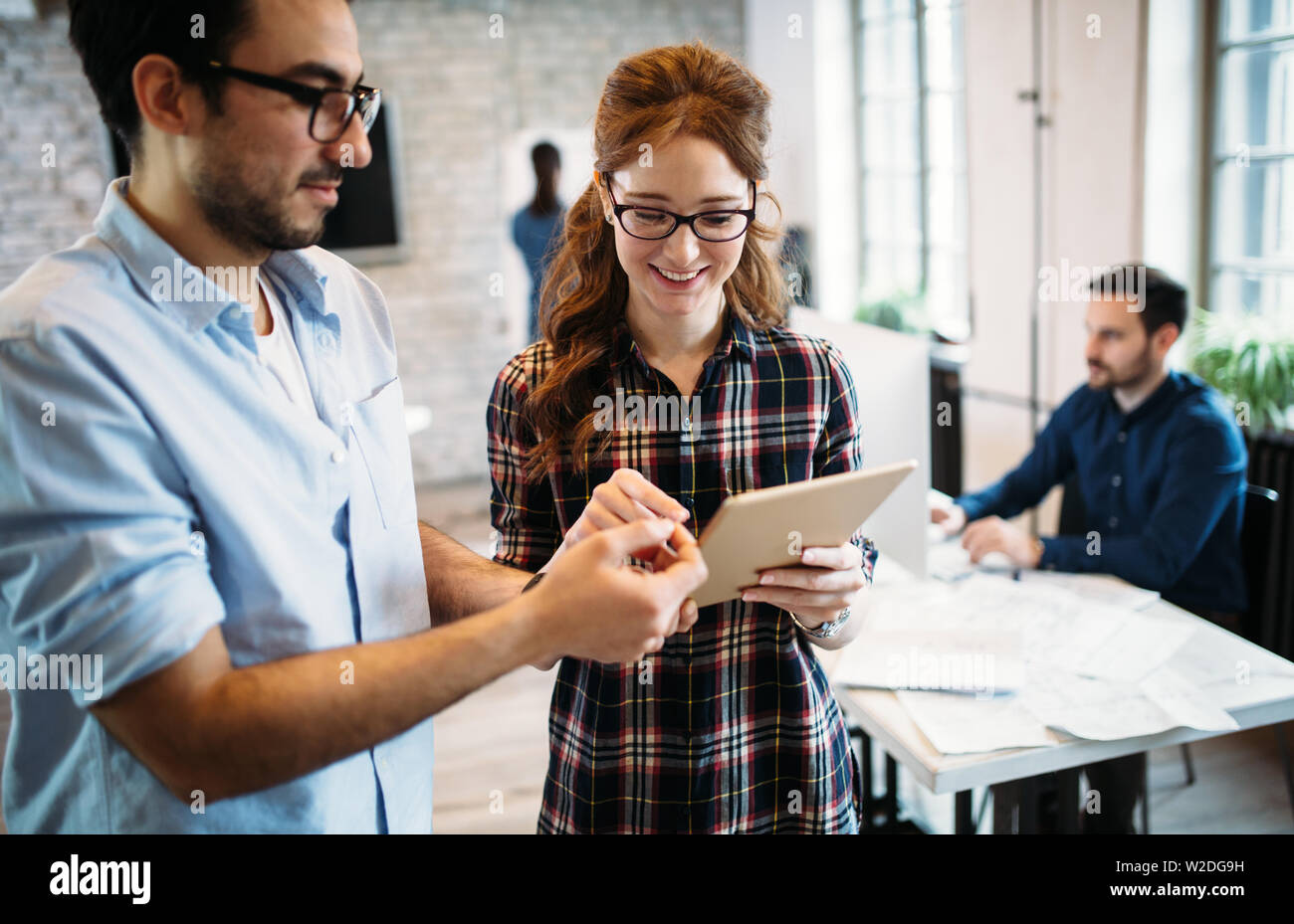 Portrait of architects having discussion in office Stock Photo - Alamy