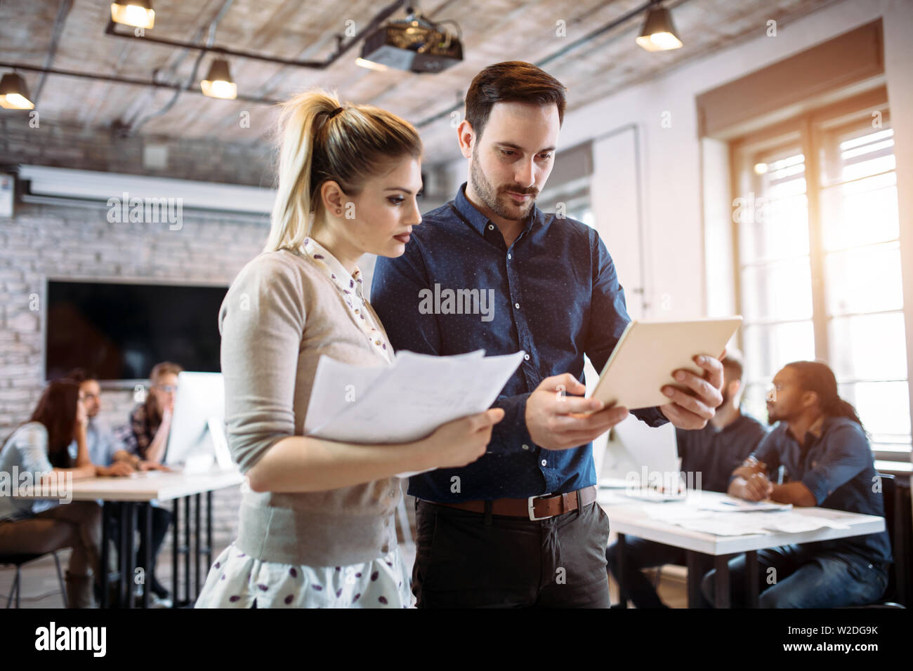 Portrait of architects having discussion in office Stock Photo - Alamy