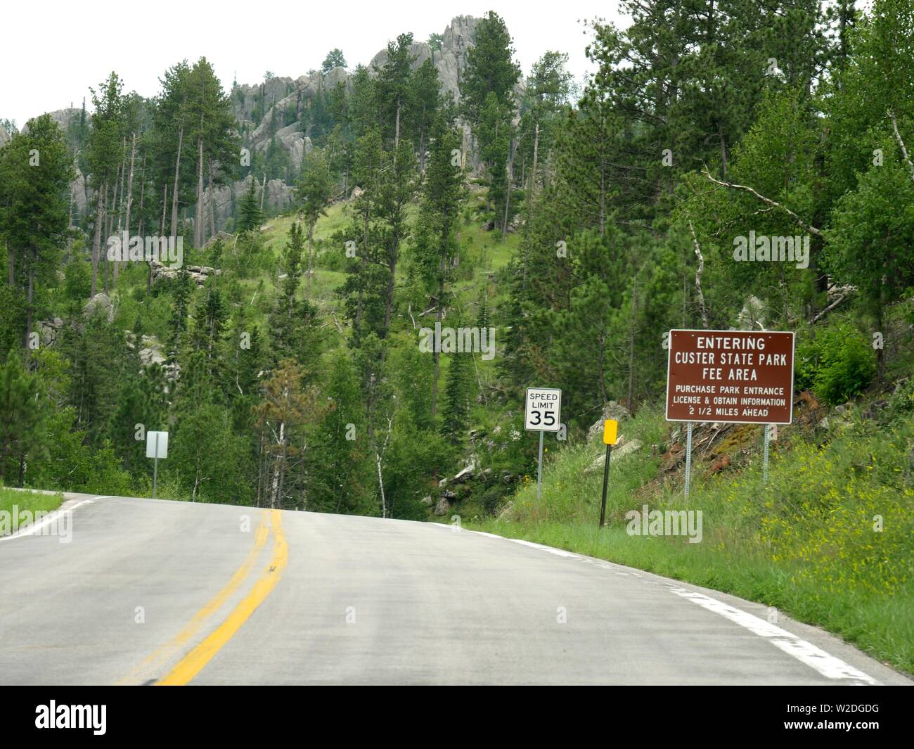 Roadside directional and speed limit signs near approaching Custer ...