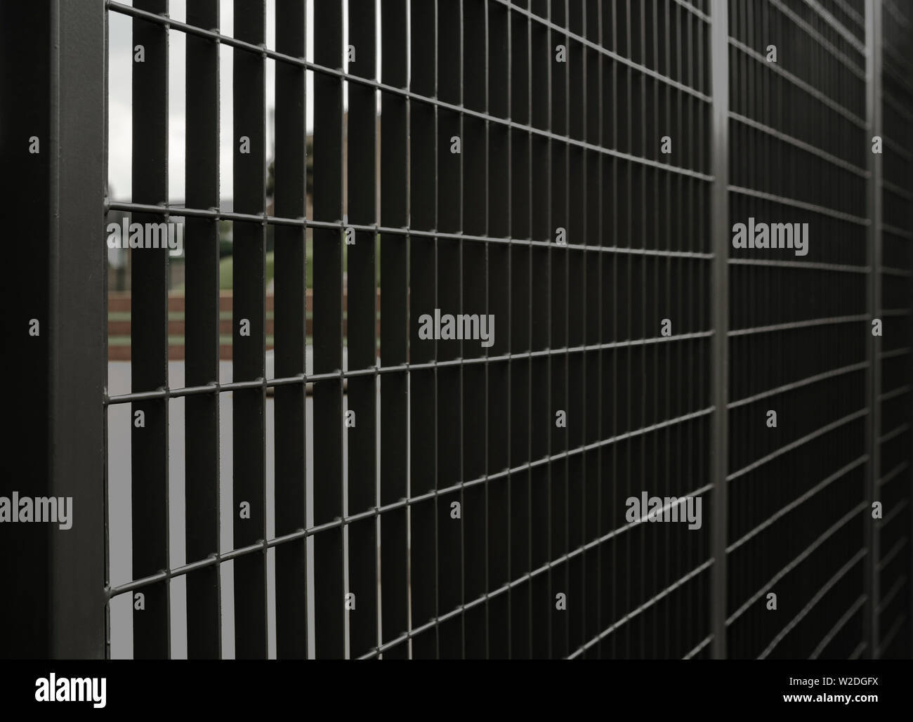 Heavy duty, galvanised flatbar metal grille used as a fence panel ...