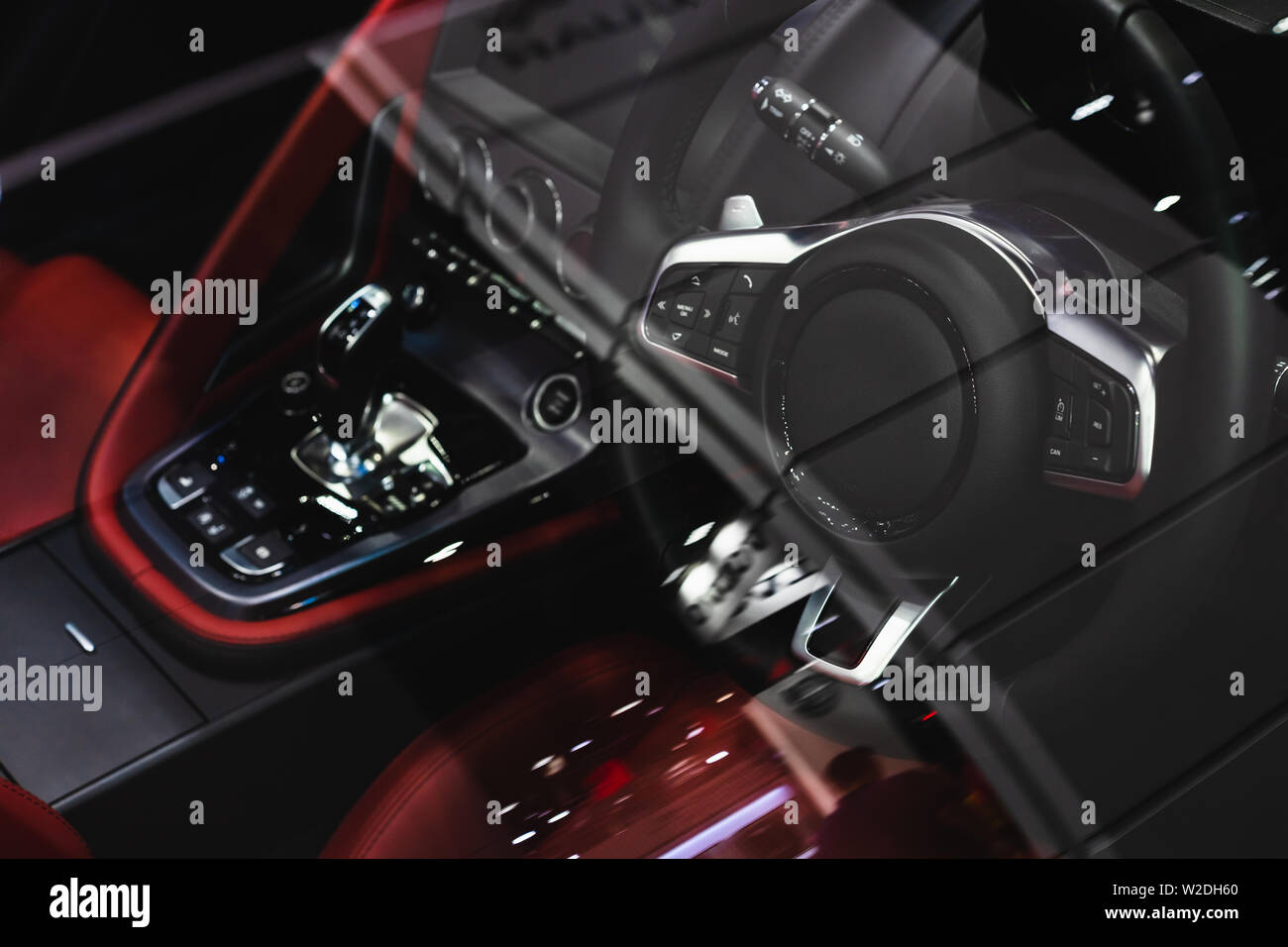 The steering wheel and interior of luxury sport car. View through the ...
