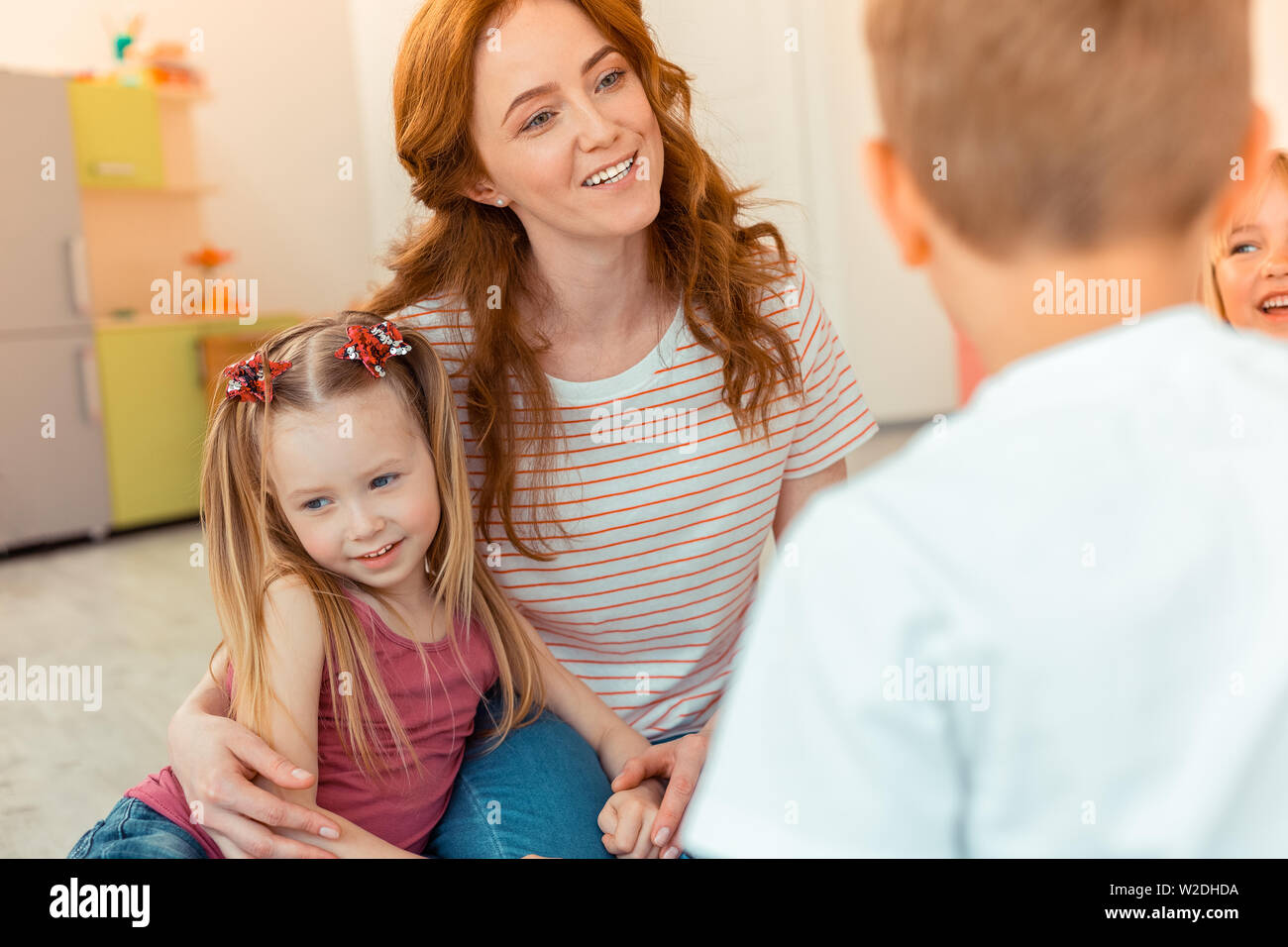 Joyful nice woman hugging a pretty girl Stock Photo - Alamy