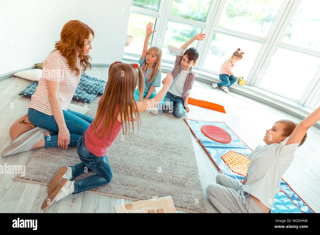 Top view of nice pretty kids raising their hands Stock Photo - Alamy