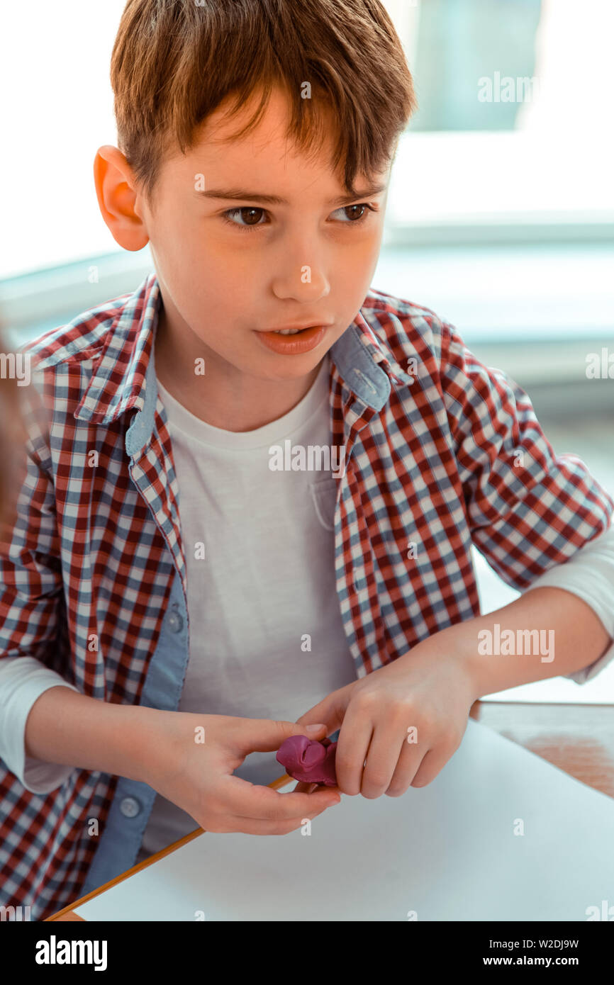 Cute creative boy wanting to make a toy Stock Photo - Alamy