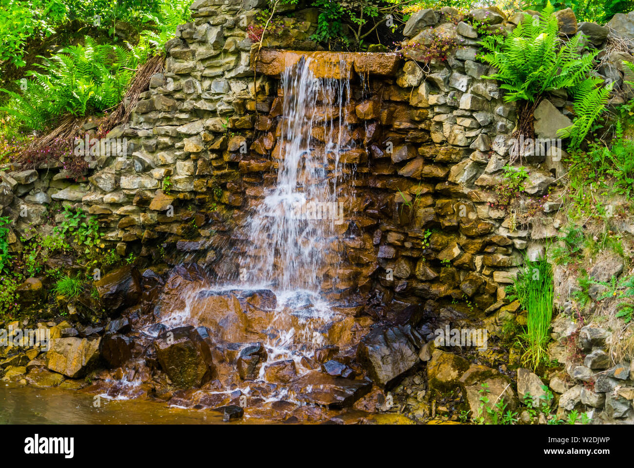 closeup of a streaming waterfall, beautiful garden architecture, Nature ...