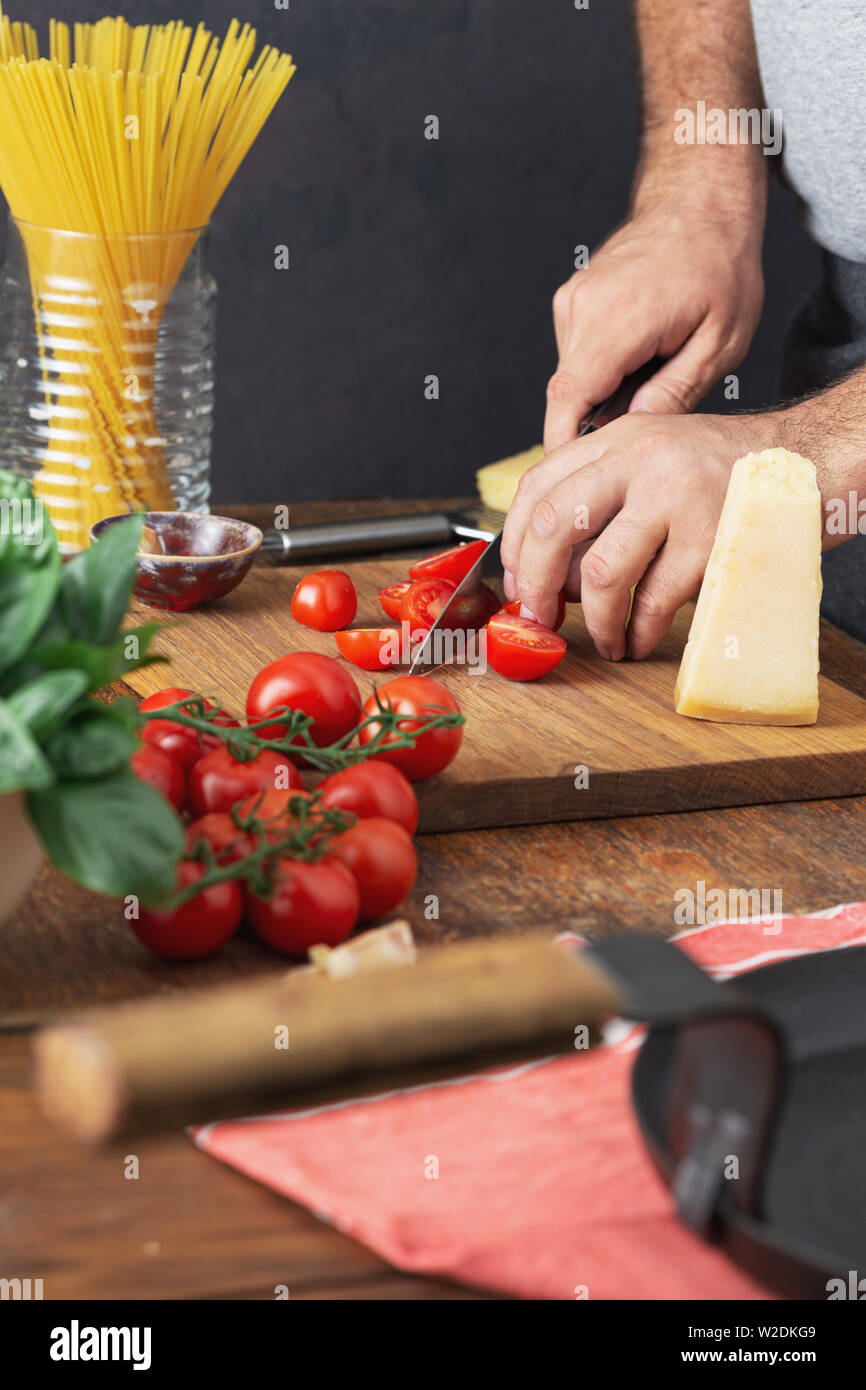 Chef cooking pasta with tomatoes in the kitchen Stock Photo - Alamy