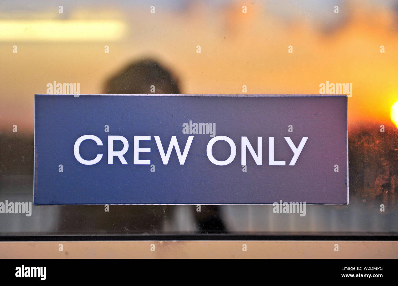 Crew only sign with beautiful sunset on background Stock Photo - Alamy