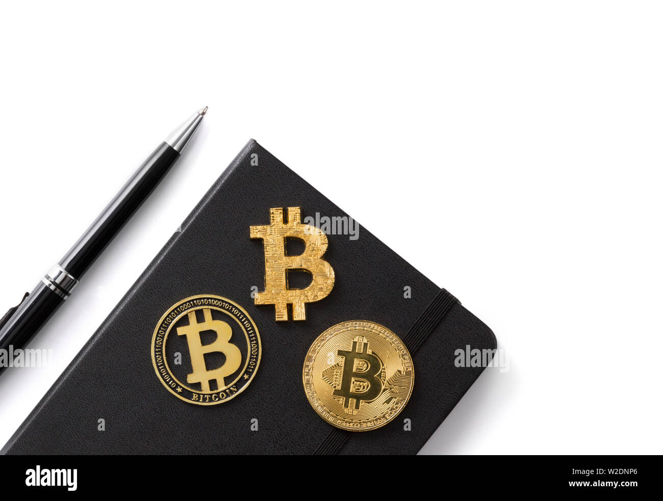 Close Up three bitcoin coins, notepad and pen isolated on white.Top ...