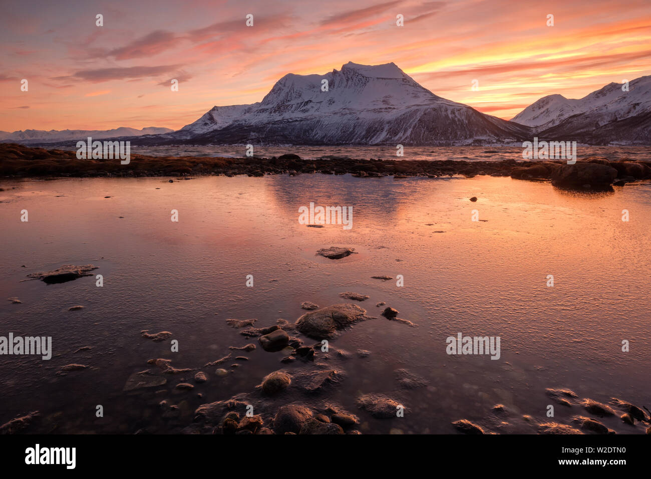 Scandinavian landscape with frozen fjord and mountain in winter at ...
