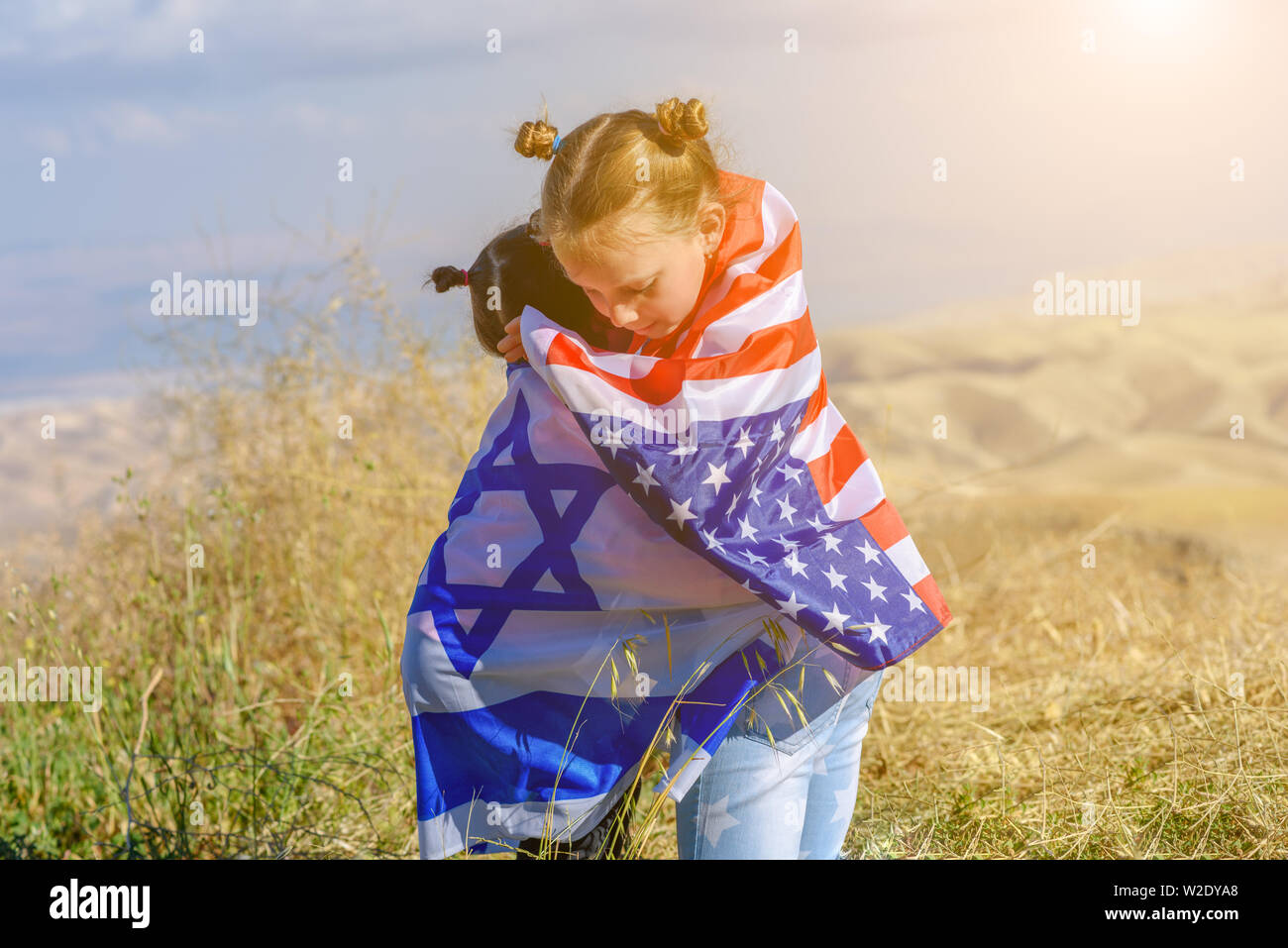 Two cute girls with American and Israel flags. Little children holding ...