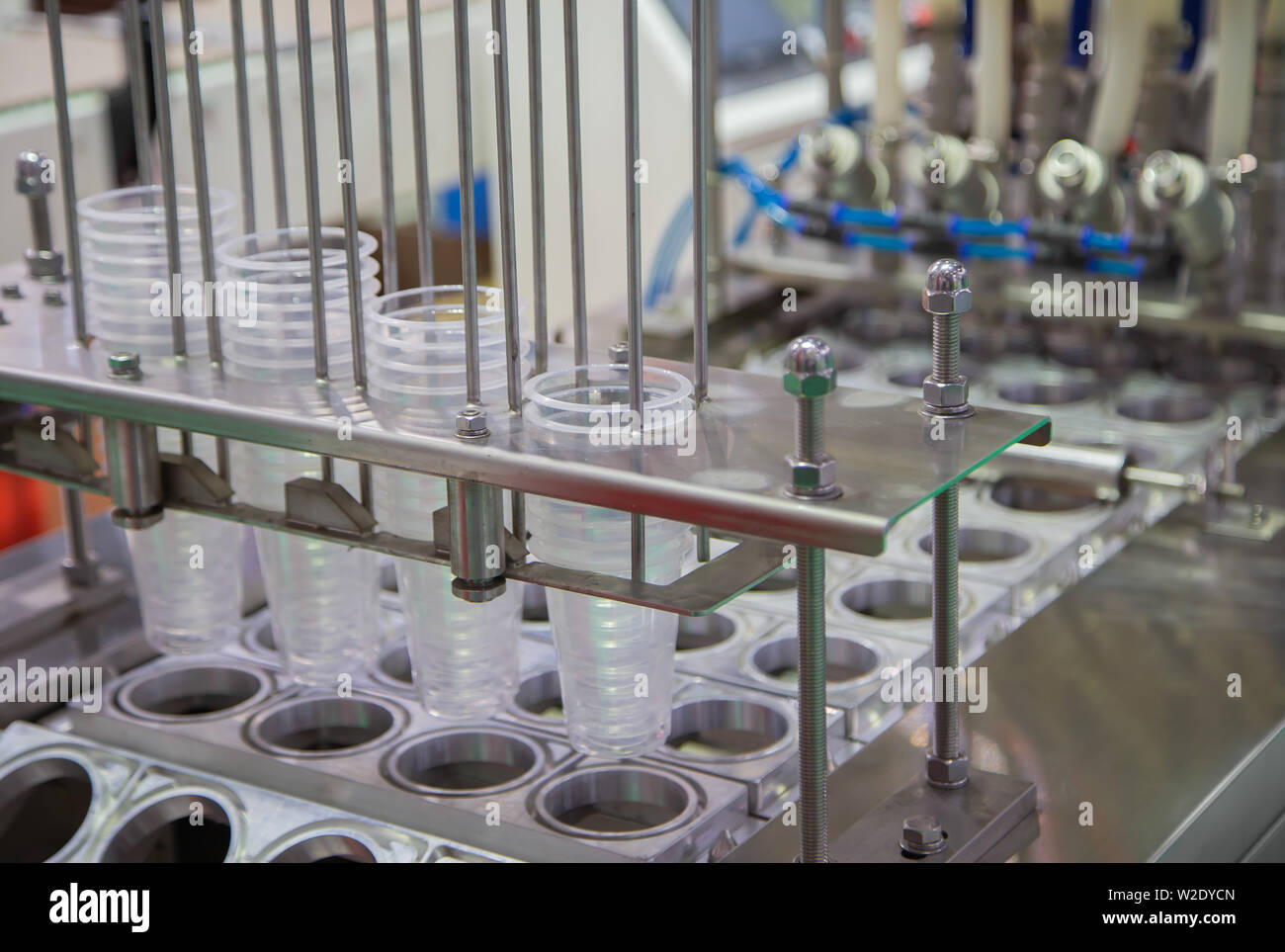 Series automatic cup filling and sealing machine Stock Photo - Alamy