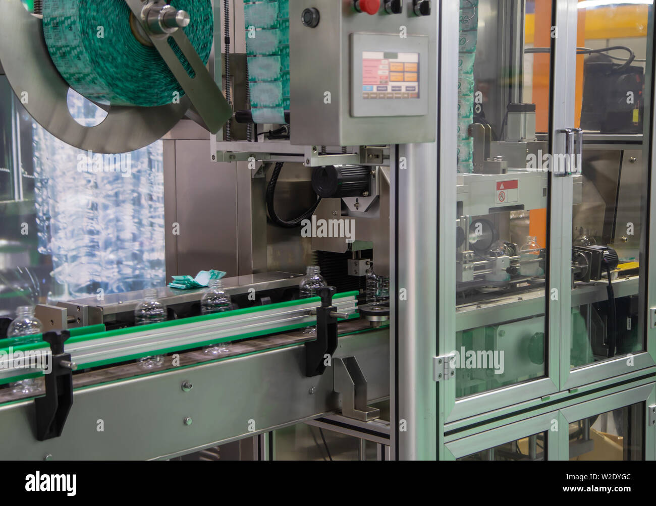 Process of PET plastic bottle on automatic sleeve labeling machine ...