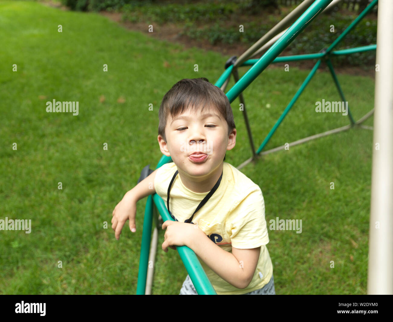 3/4 portrait of boy in play structure Stock Photo - Alamy