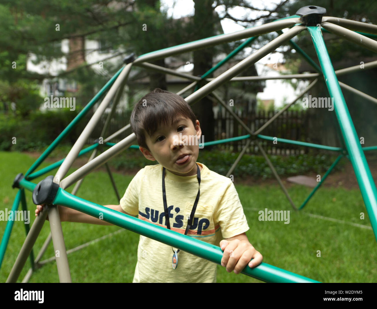 boy facing camera inside play structure Stock Photo - Alamy