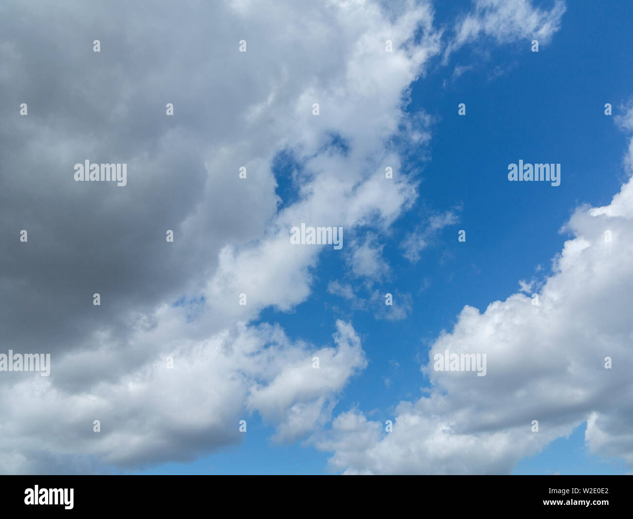 Blue sky with light cloud covering Stock Photo - Alamy