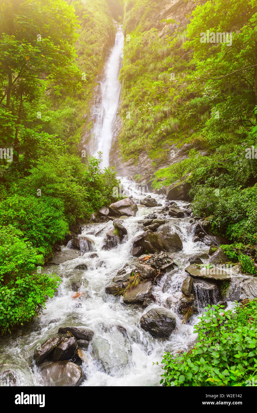 Beautiful mountains landscape with waterfall, stones and green plants ...