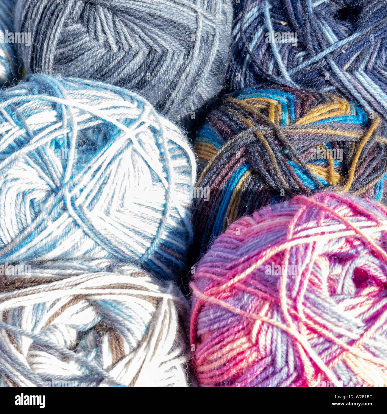 Close-up of colourful balls of wool on the sales stand of a flea market ...