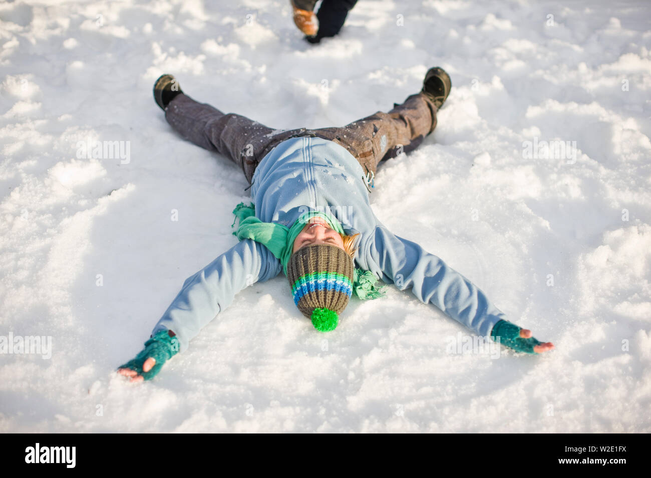 Woman making snow angel hi-res stock photography and images - Alamy