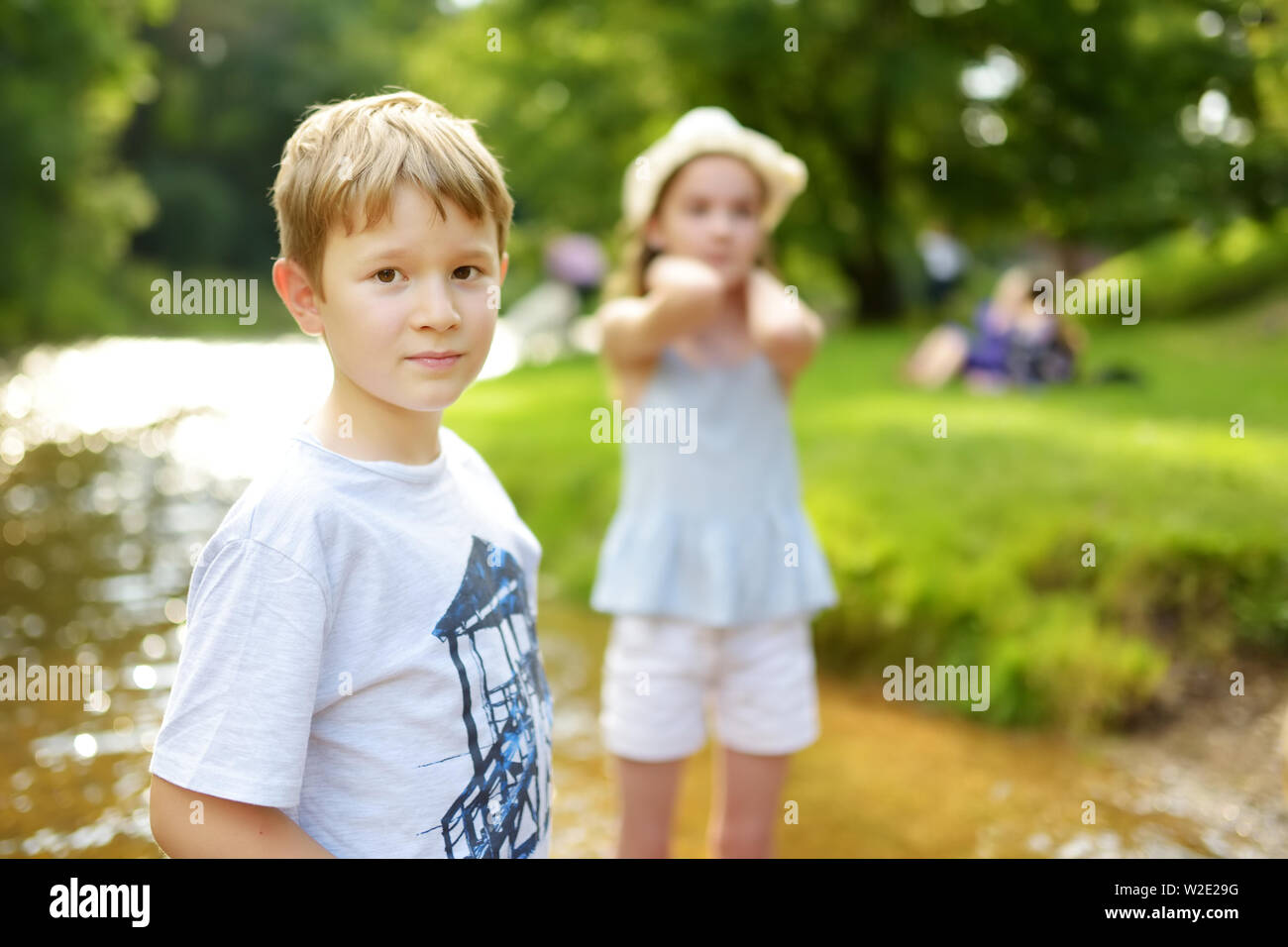 Brother and sister having fun together on warm and sunny summer day in ...