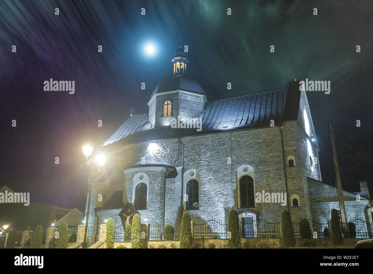 The beautiful medieval church in the night light and fog Stock Photo ...
