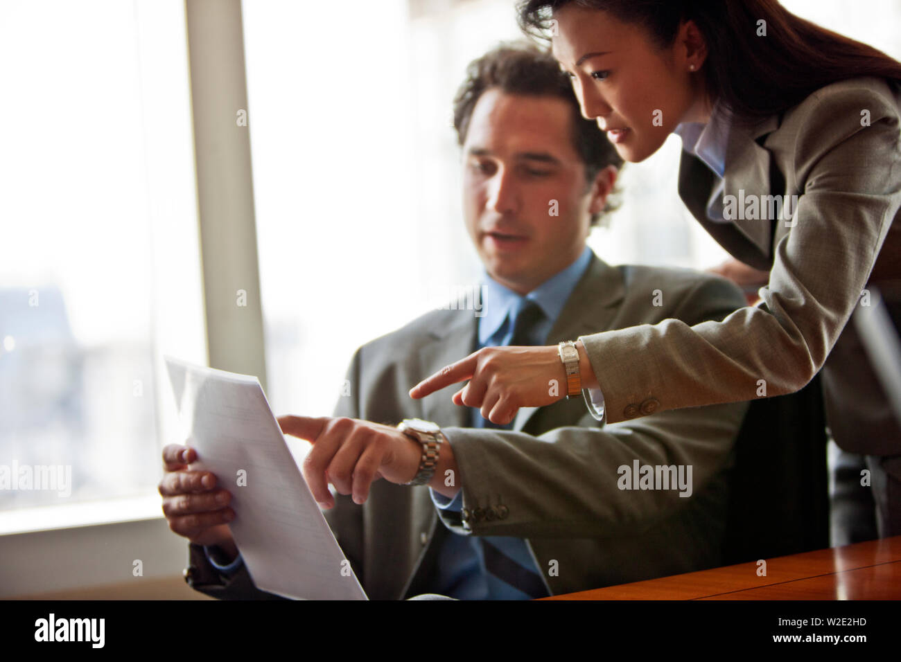 Two business colleague looking over important documents together Stock ...