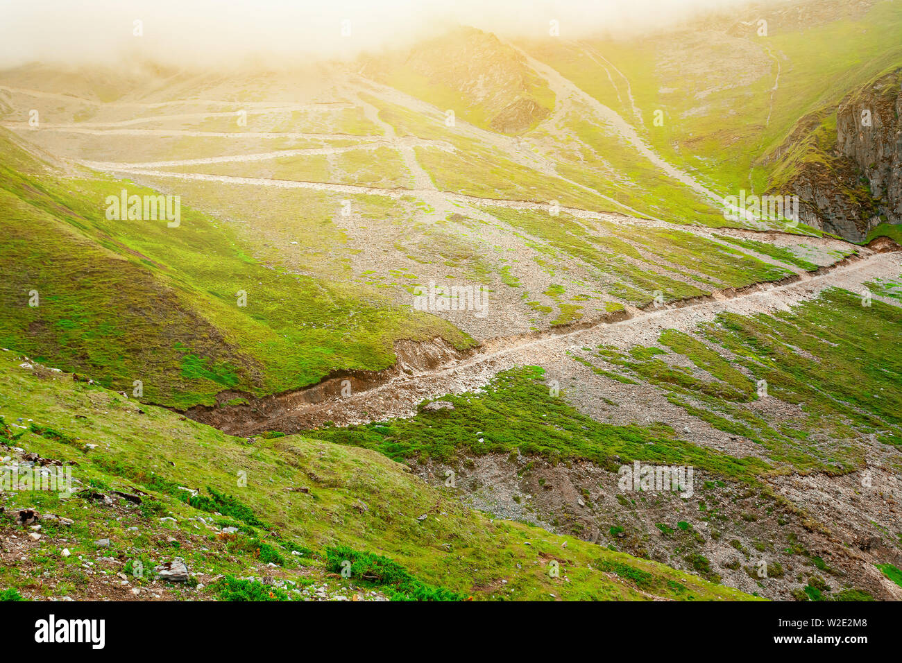 rural roads, rocks and green grass under sunshine Stock Photo - Alamy