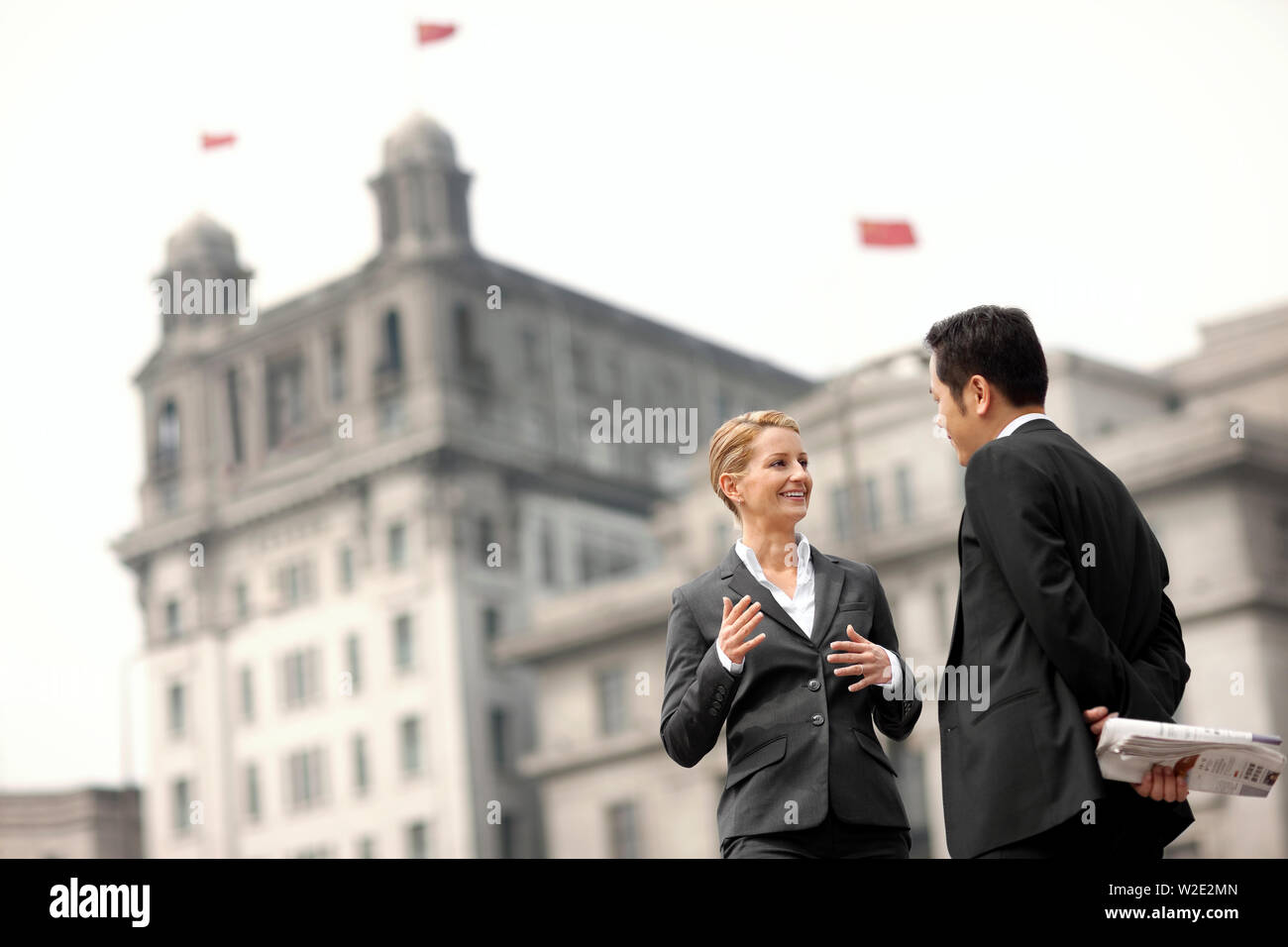 Mid adult business people having a conversation outside Stock Photo - Alamy