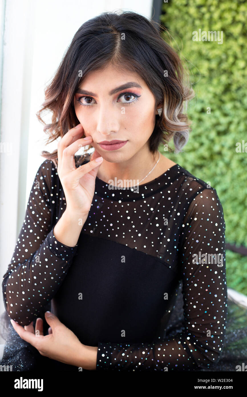Portrait hispanic woman with fashionable clothes and makeup in high ...